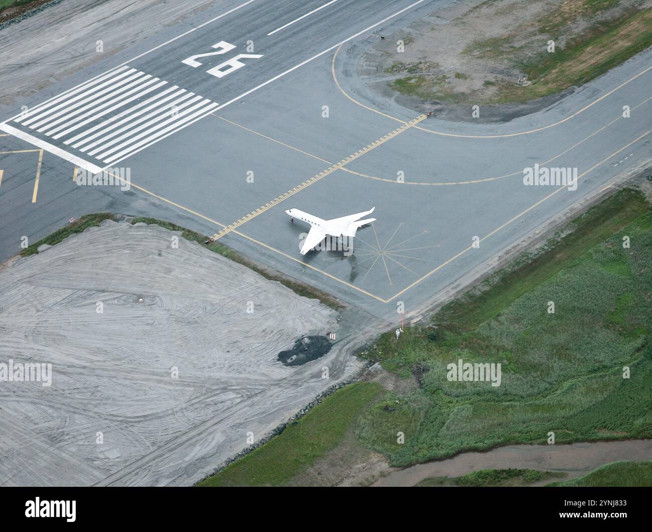 Aerial shot capturing a private jet positioned on a remote runway ...