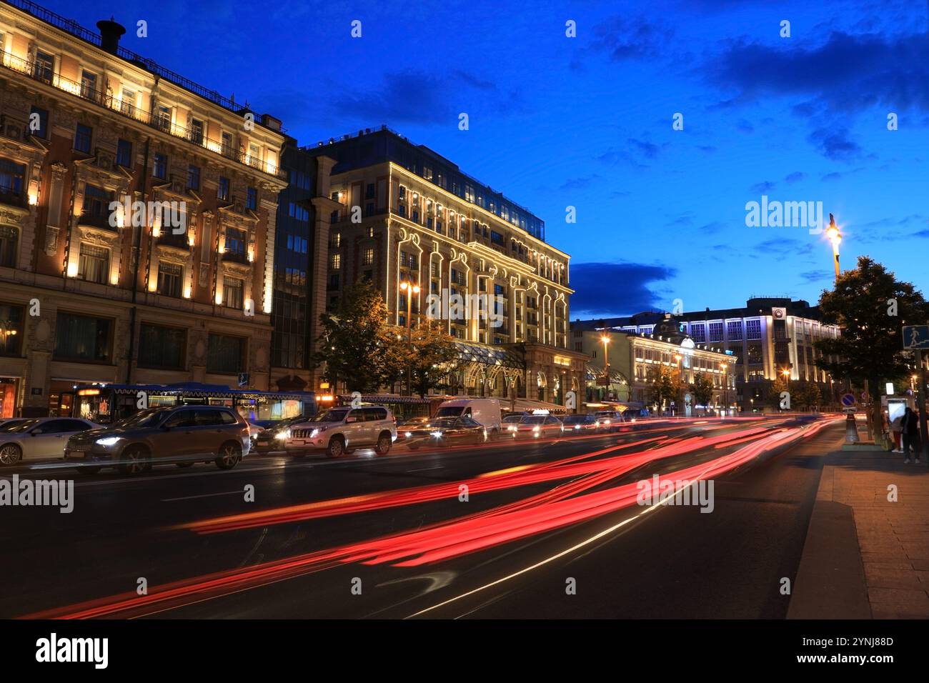 Night view of the urban city street with busy highway and neon lights ...