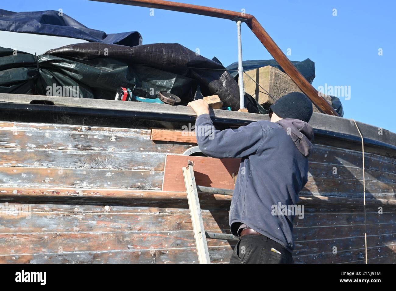 Working on Rummy 3 replacing planks and seams at Southwold Stock Photo ...