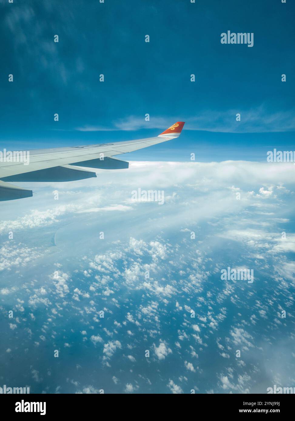 "Scenic Aerial View of Airplane Wing Above Fluffy Clouds and Vast Sky, Capturing the Serenity of ...