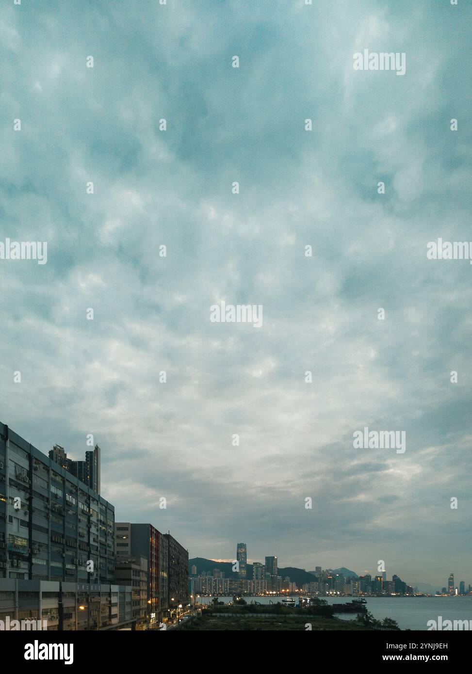 "Panoramic View of Urban Waterfront Skyline Under Dramatic Cloudy Sky ...