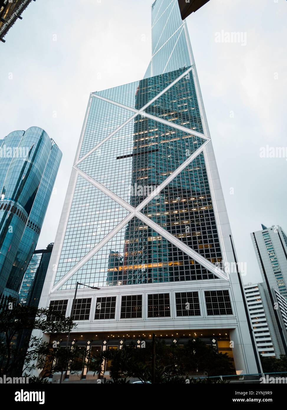 Modern Skyscraper with Geometric Facade and Reflective Glass in a Bustling Urban Cityscape Stock ...