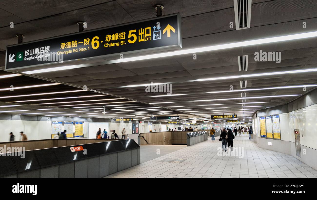 Modern Subway Station Interior with Directional Signage, Passengers ...