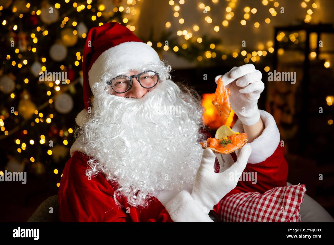 Jolly Santa Claus eating gravlax sandwich, traditional Scandinavian and ...