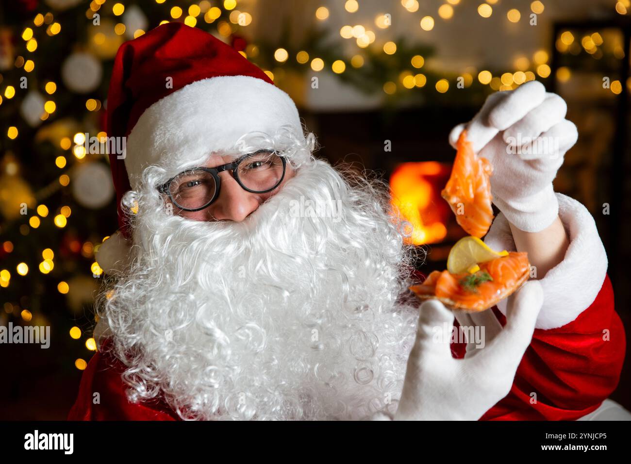 Jolly Santa Claus eating gravlax sandwich, traditional Scandinavian and ...