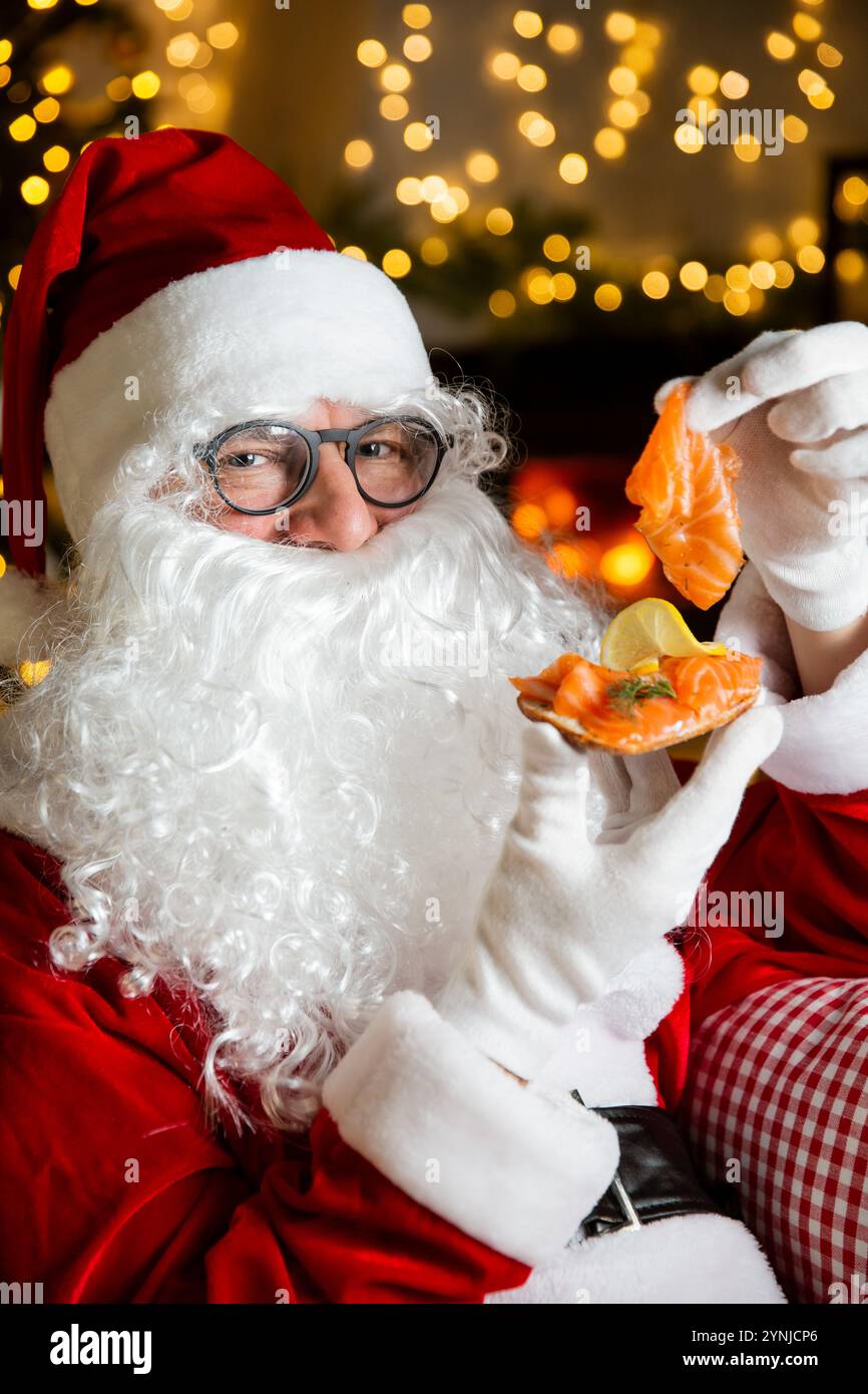 Jolly Santa Claus eating gravlax sandwich, traditional Scandinavian and ...