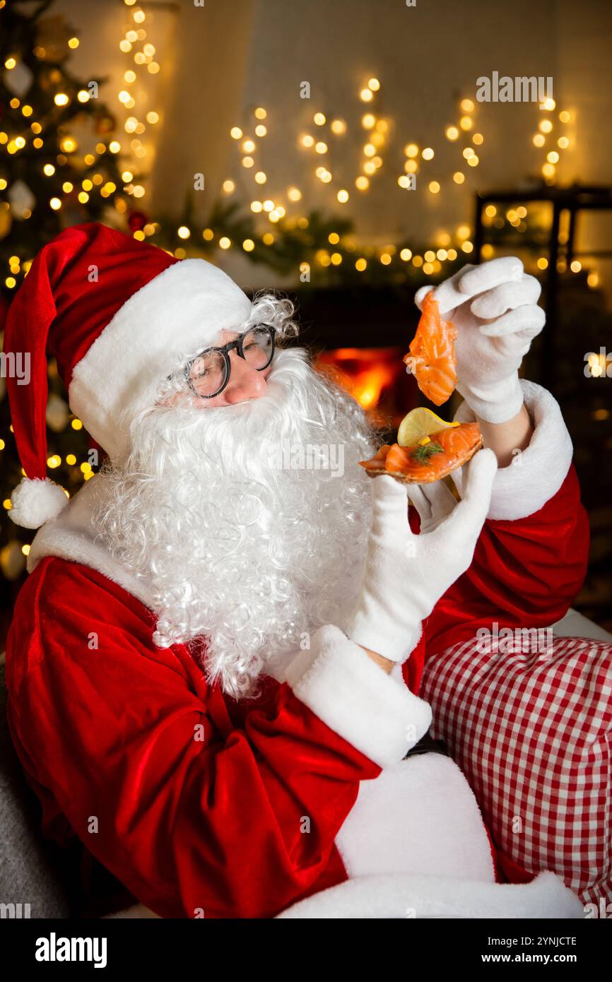 Jolly Santa Claus eating gravlax sandwich, traditional Scandinavian and ...