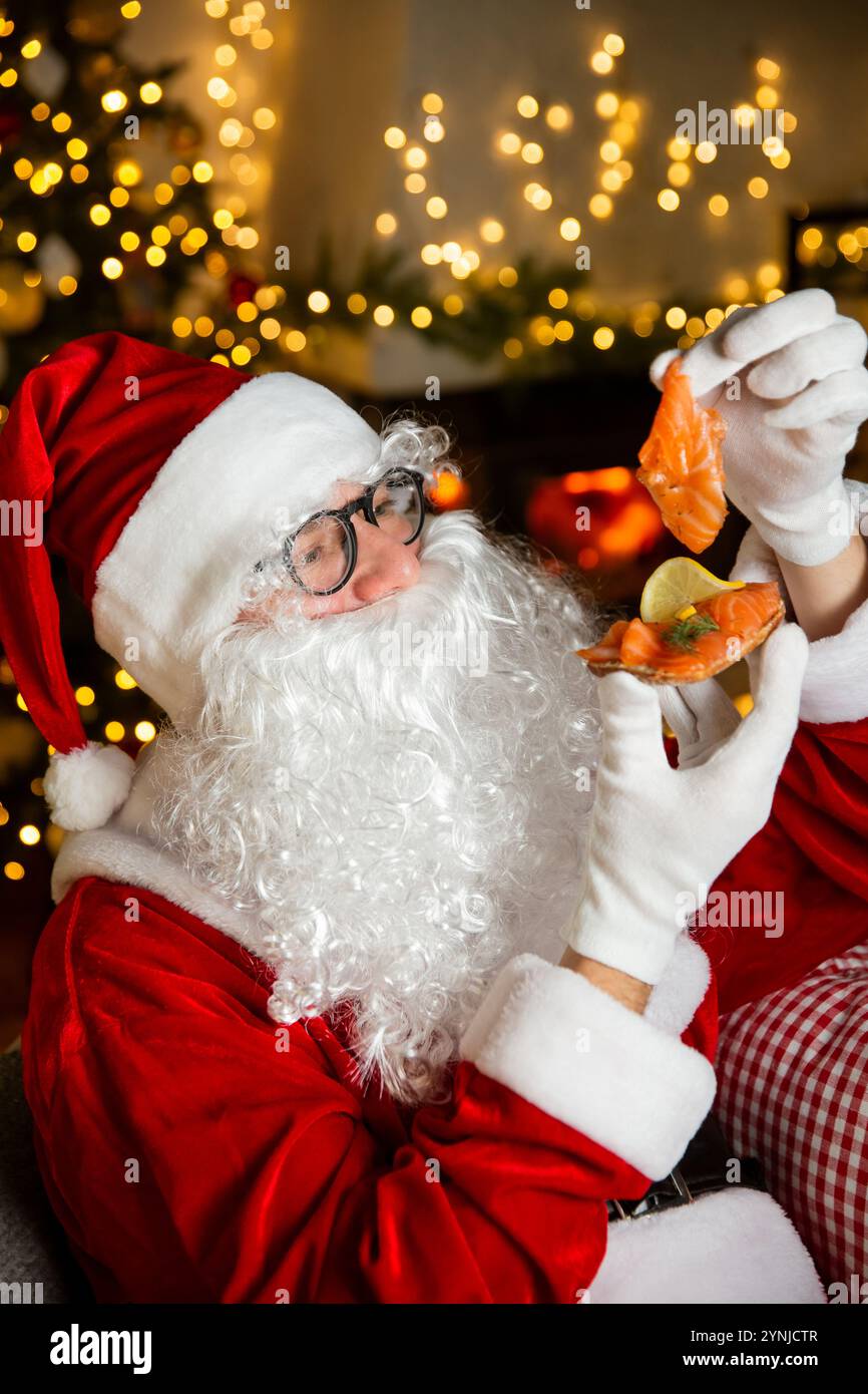 Jolly Santa Claus eating gravlax sandwich, traditional Scandinavian and ...