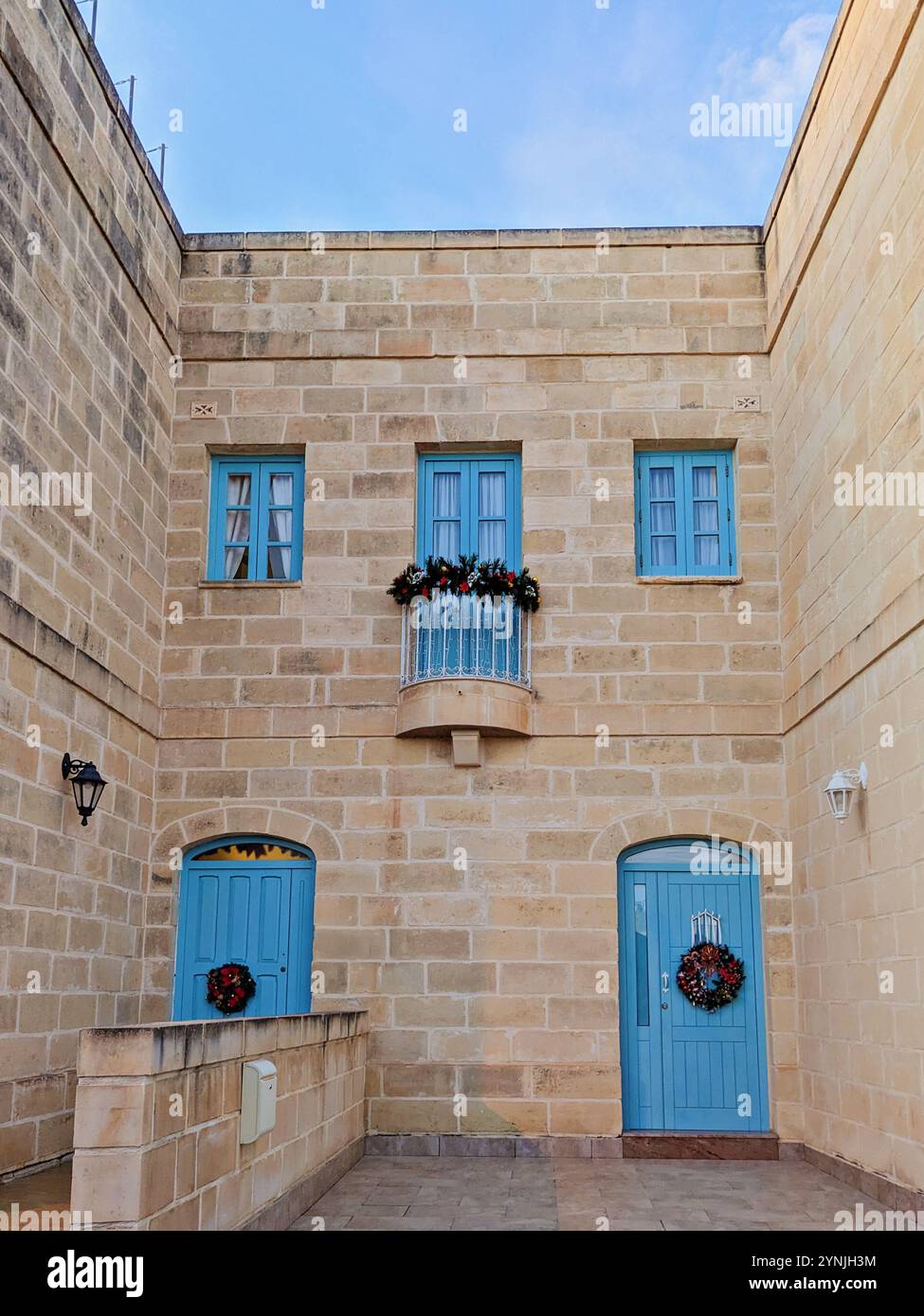 Rustic Stone Building with Festive Doors and Windows Stock Photo - Alamy