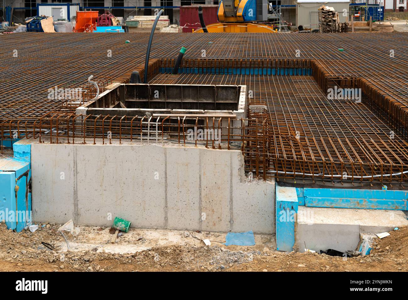 Workers are busy at a construction site where a foundation is being ...