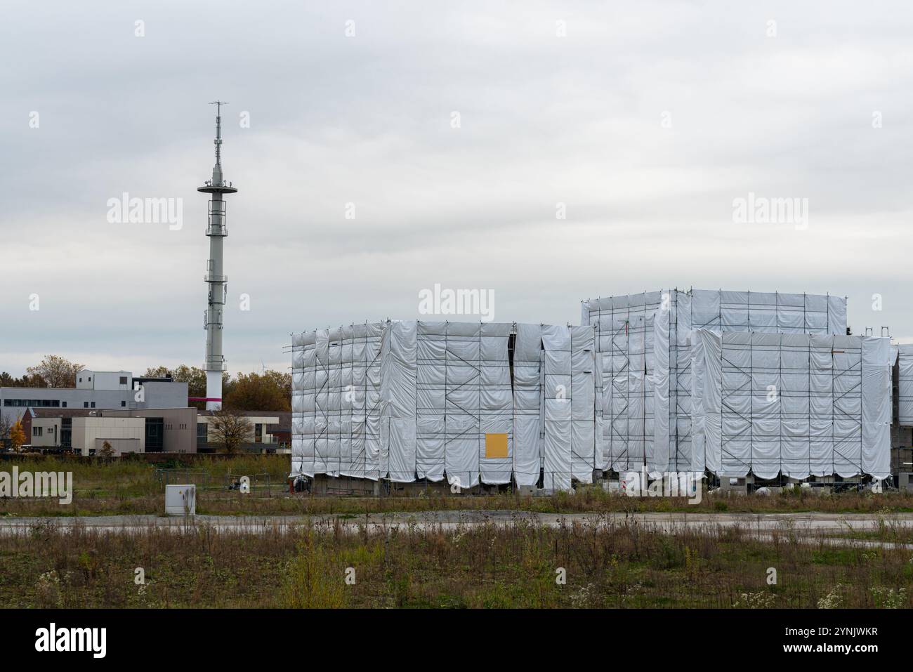 Covered structures are seen at a construction site near a communication ...