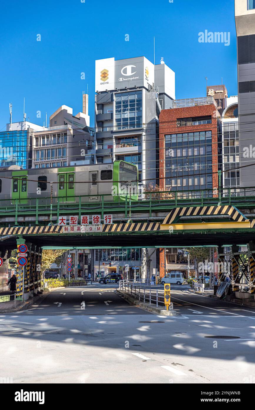 Commuter train passing over city street in urban japan tokyo Stock ...