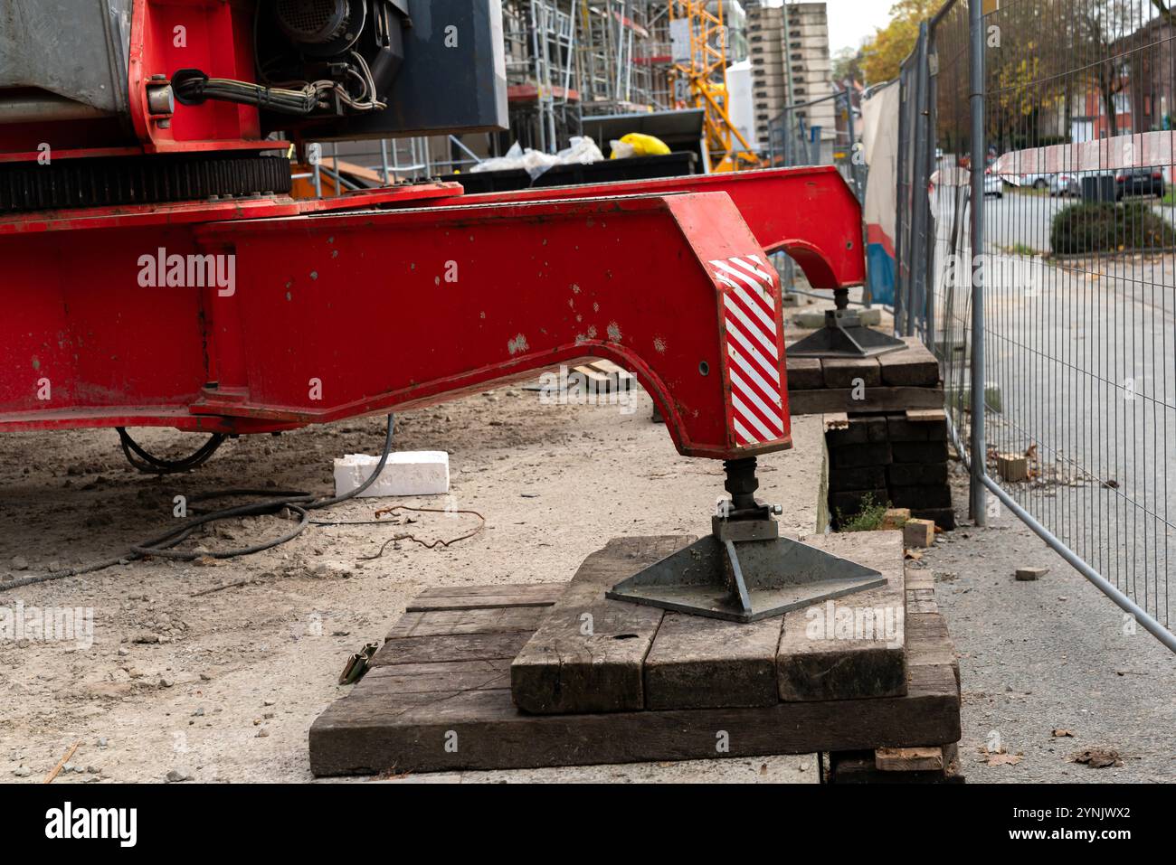 Hydraulic support of crane on construction site placed on wooden blocks ...
