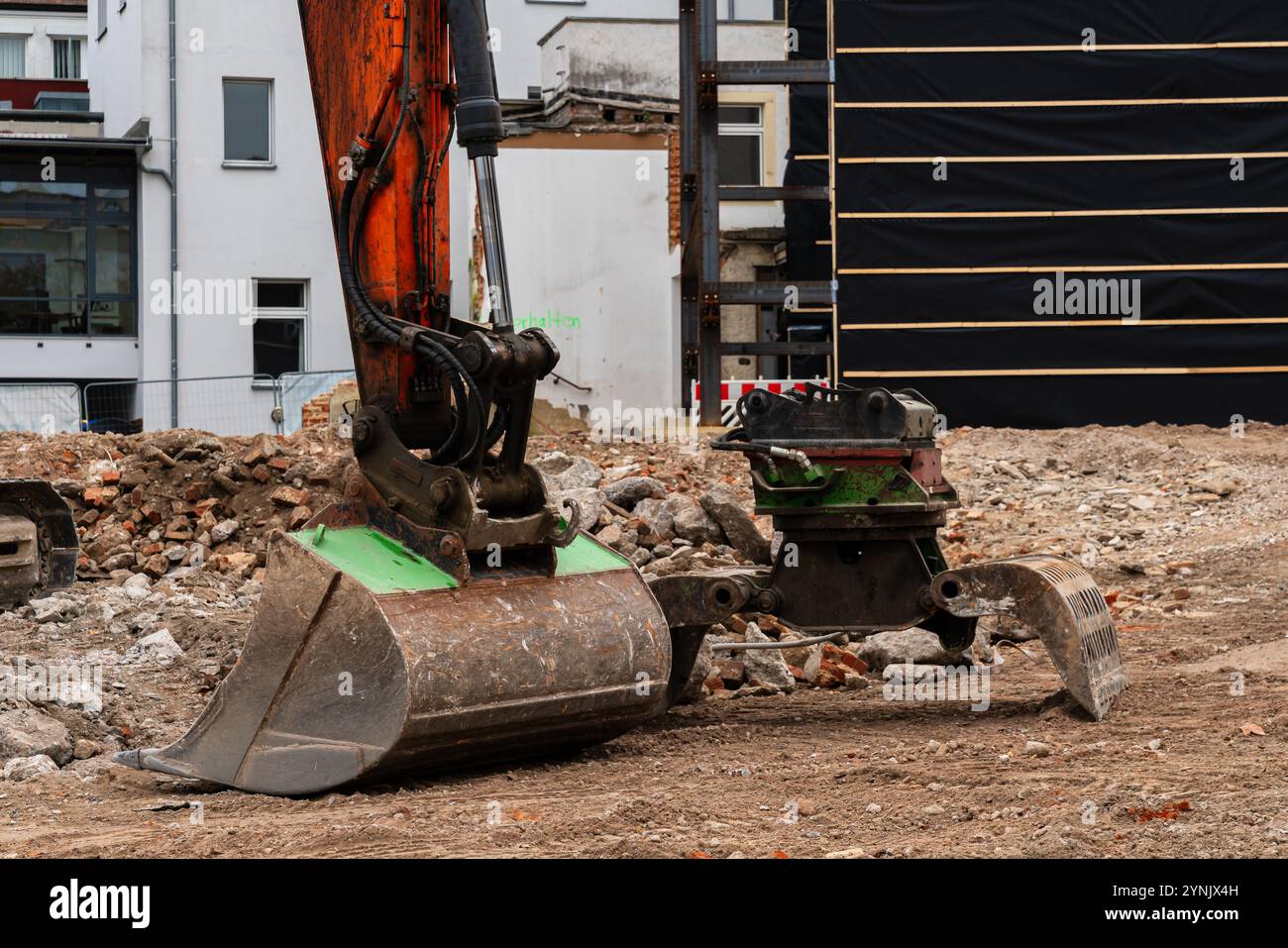 An excavator works diligently at a construction site, moving gravel and ...