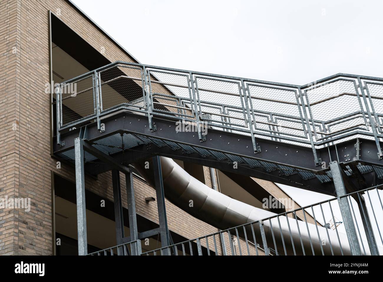 A metal ramp leads to an upper level, featuring a long slide beside it ...