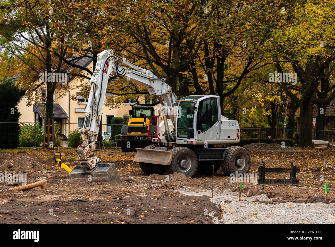 Construction activity is underway with an excavator moving earth in a ...