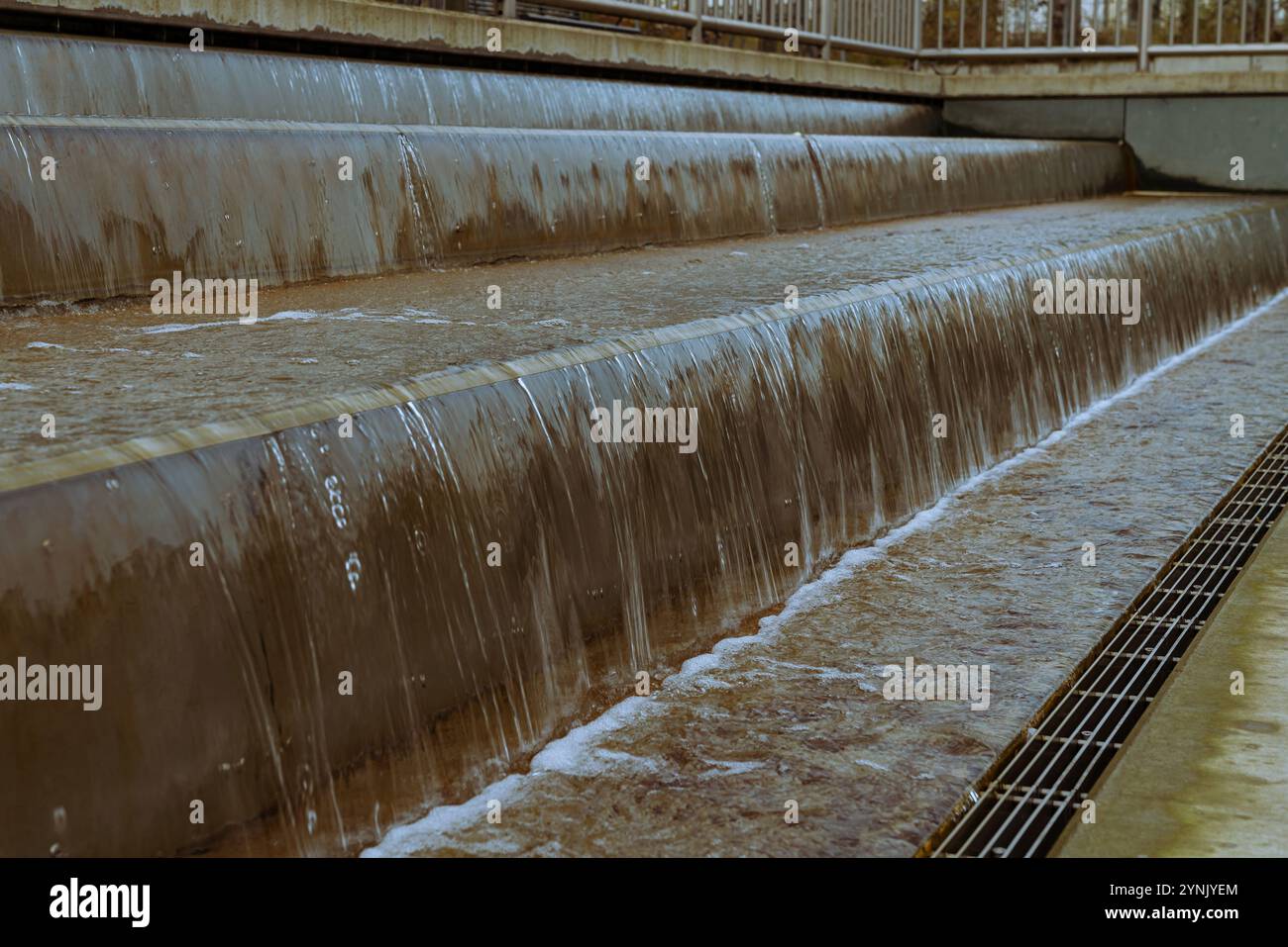 Water flows smoothly over concrete steps at a treatment facility ...