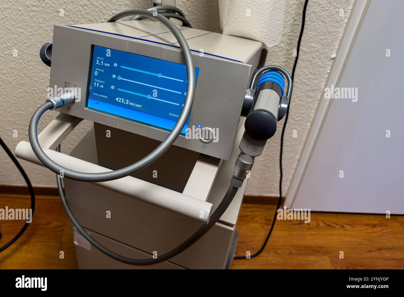 Modern medical device is displayed on a stand, with controls and ...