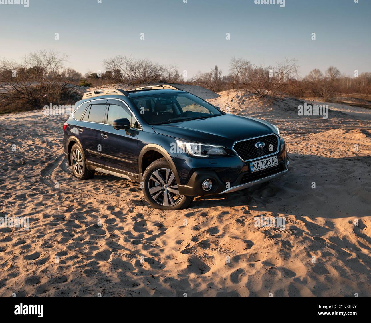 Blue Subaru outback in the desert. Three quarter front view of Japanese ...