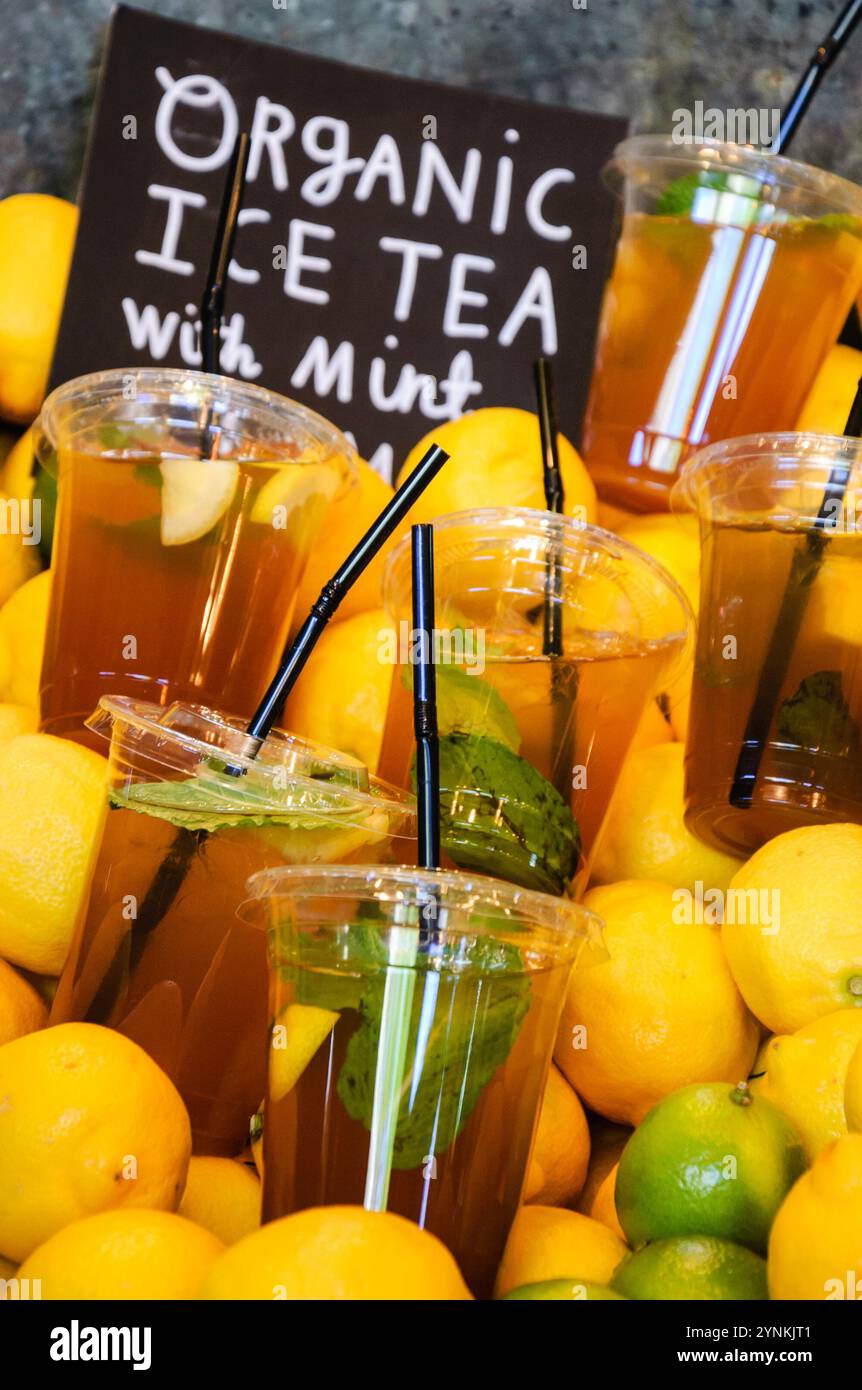 Fresh organic cold tea with lime, mint and lemon arranged in plastic ...