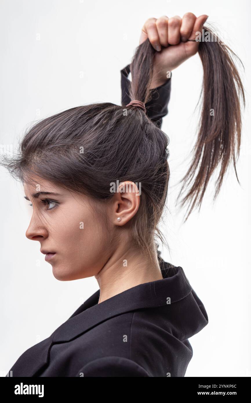 Stressed young businesswoman on white background, pulling hair in ...