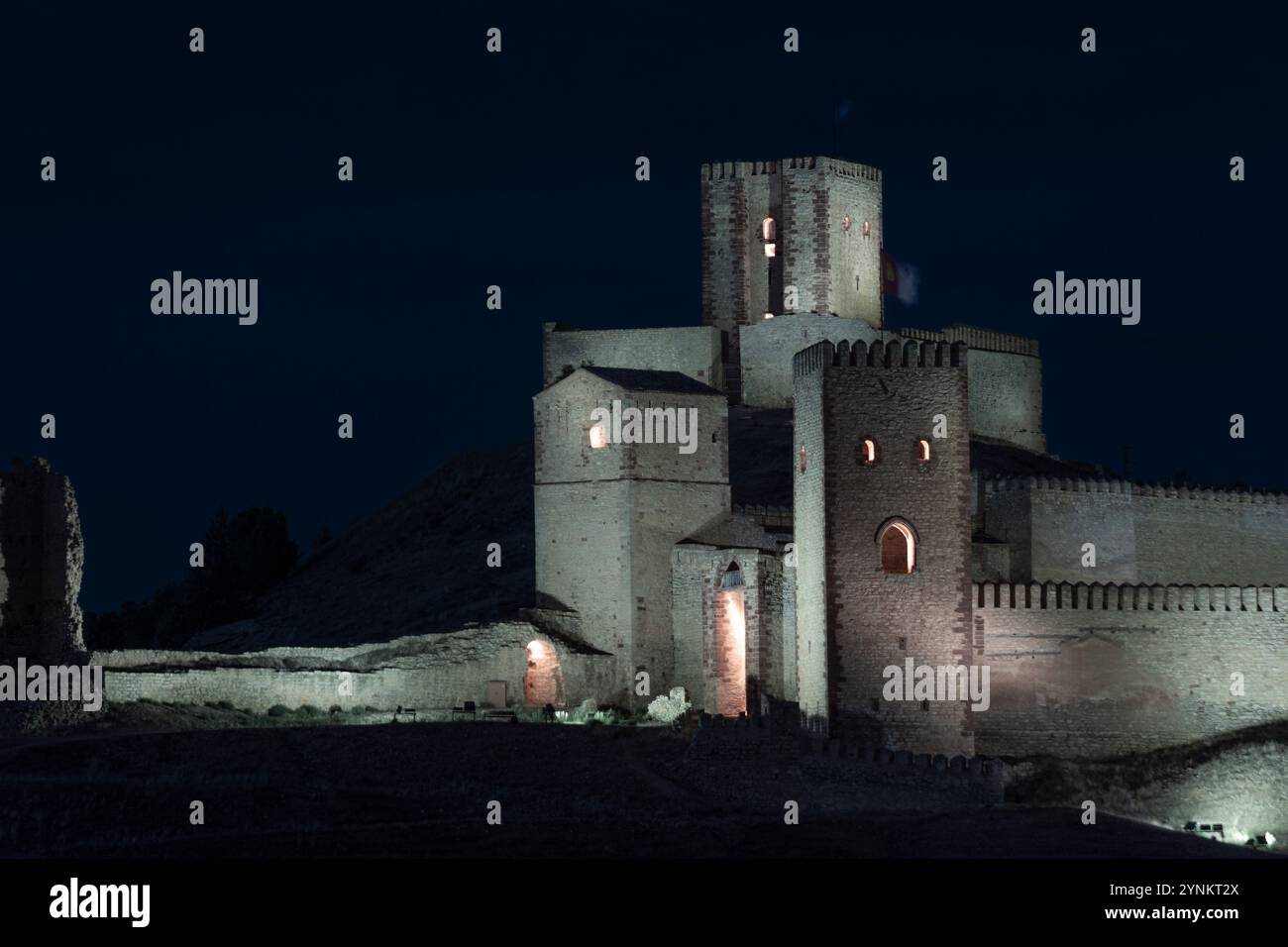 Close-up of a beautifully illuminated medieval castle at night with ...