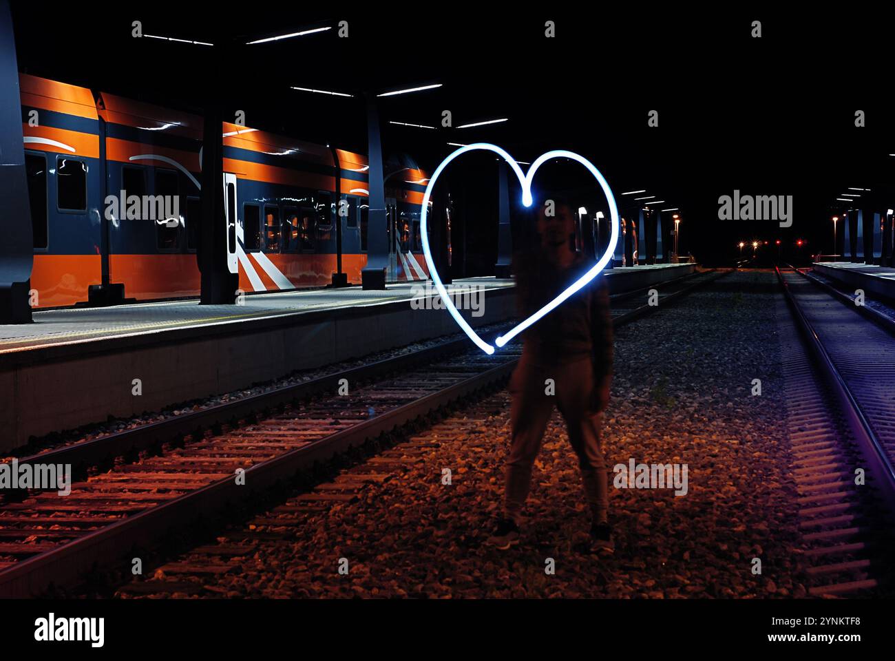 Light-painted heart shape at brightly lit modern train station Stock ...