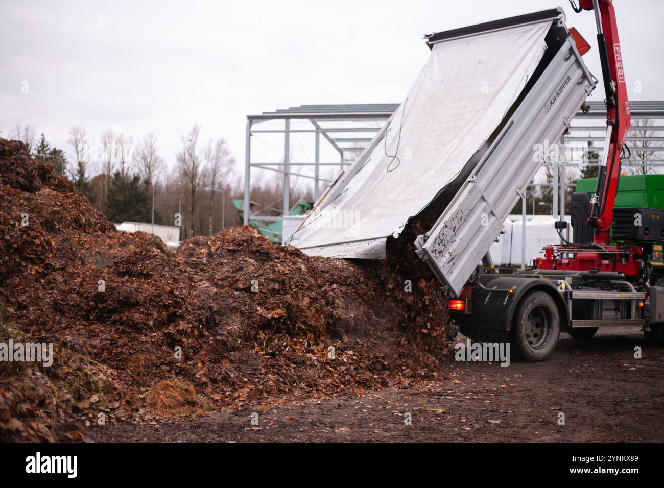 A dump truck brought new green waste for composting Stock Photo - Alamy