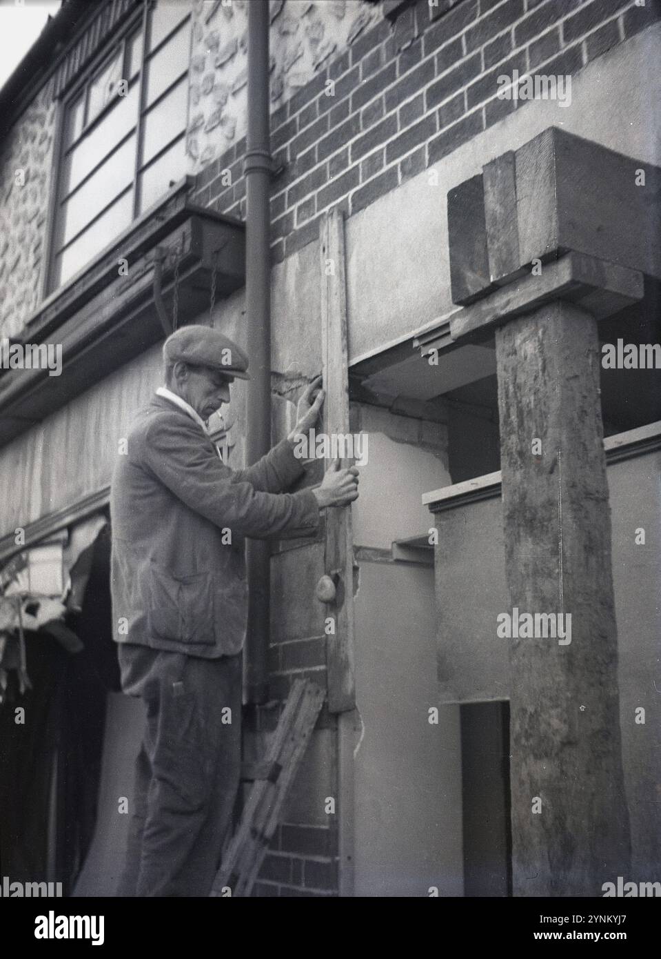 1950s, historical, outside an old building, possibly a shopfront, a ...