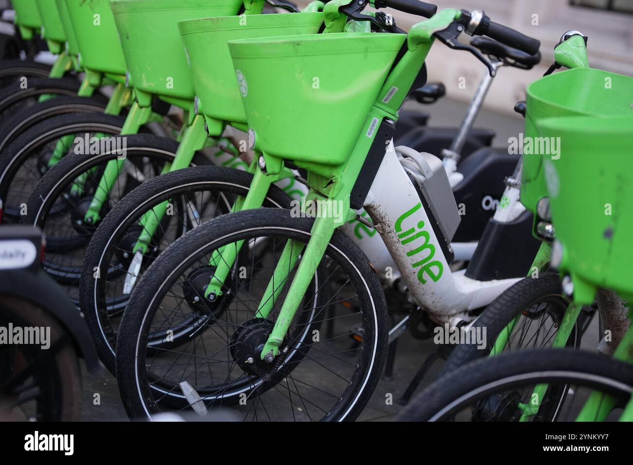 Lime e-bikes left on the pavement in Parliament Square, London. Rental e-bike operators could be ...