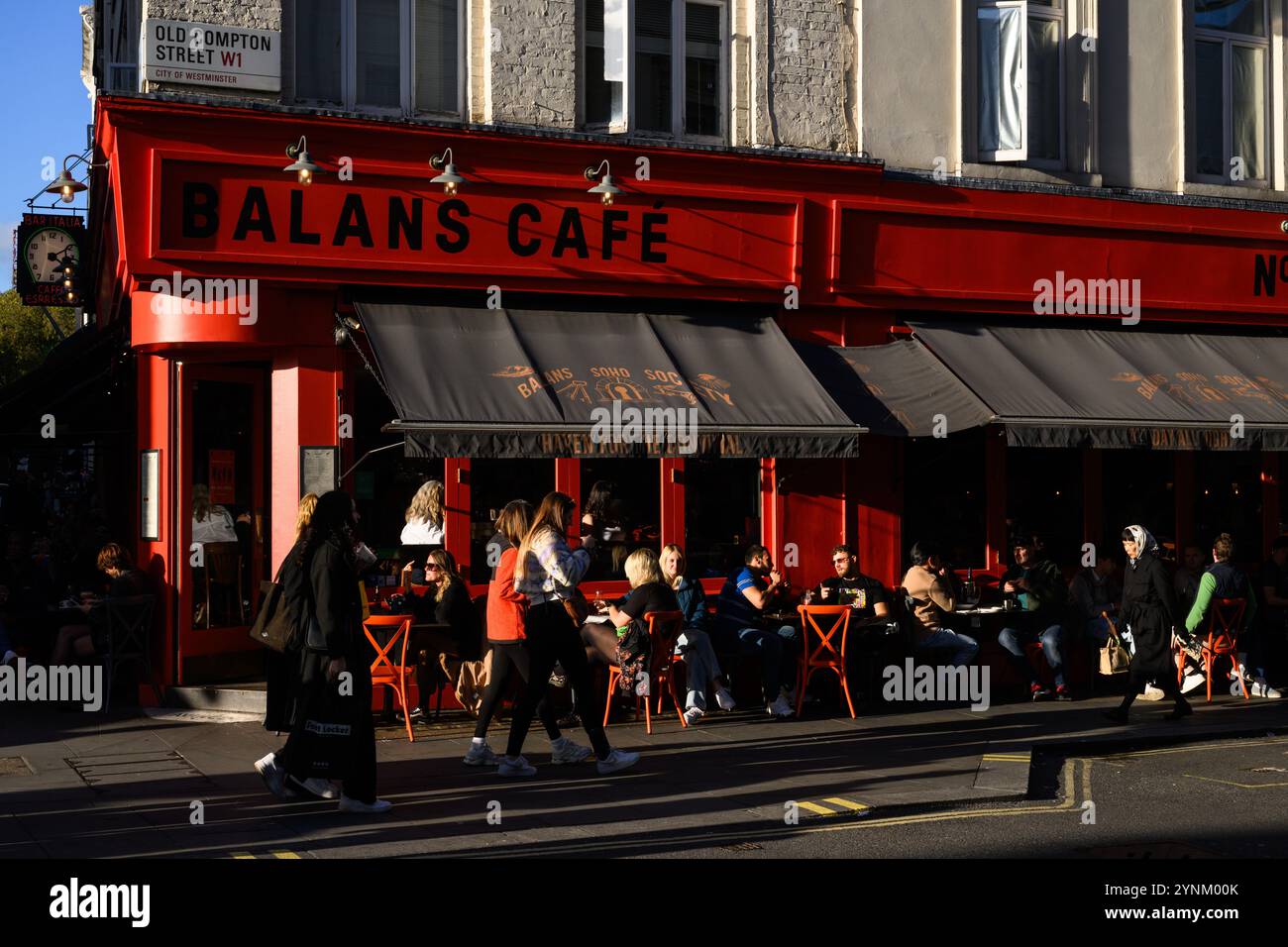 Customs sat in the afternoon sunlight at tables on the pavement outside ...