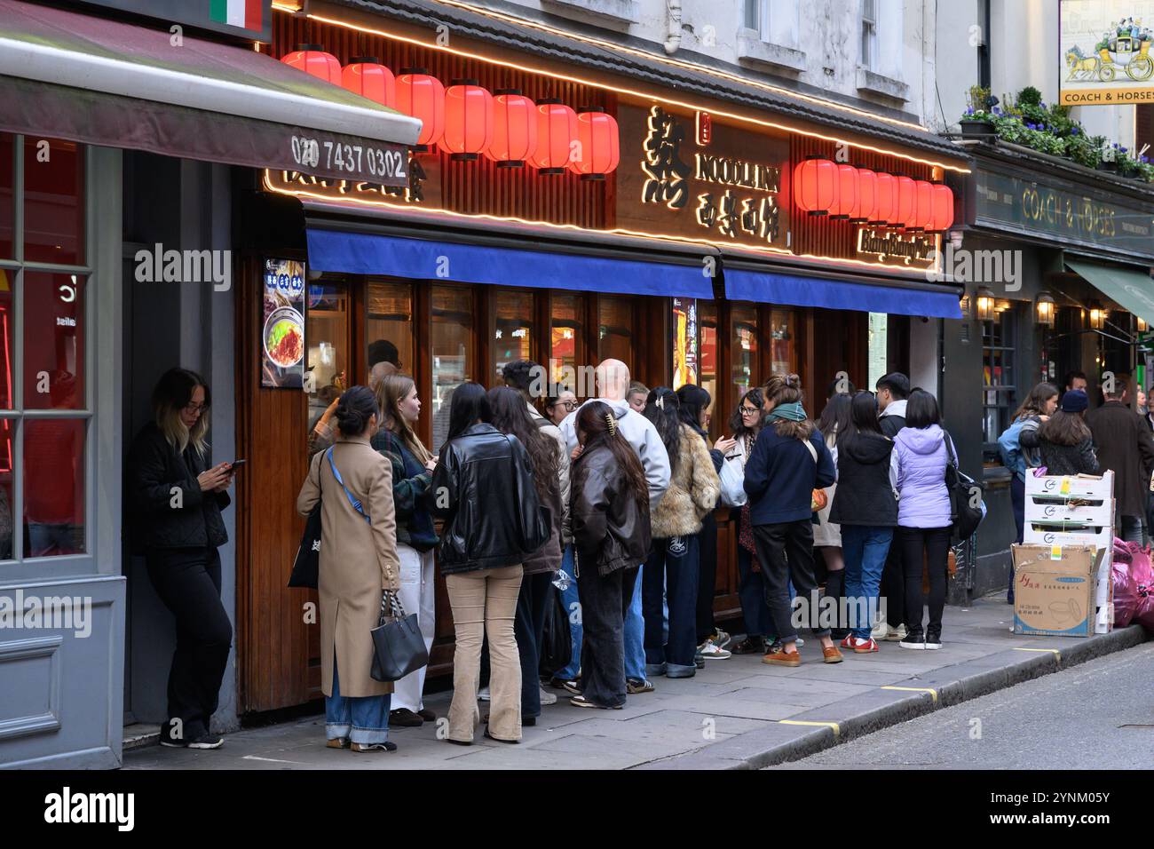 People queuing outside The Noodle Inn, Old Compton Street a Chinese ...