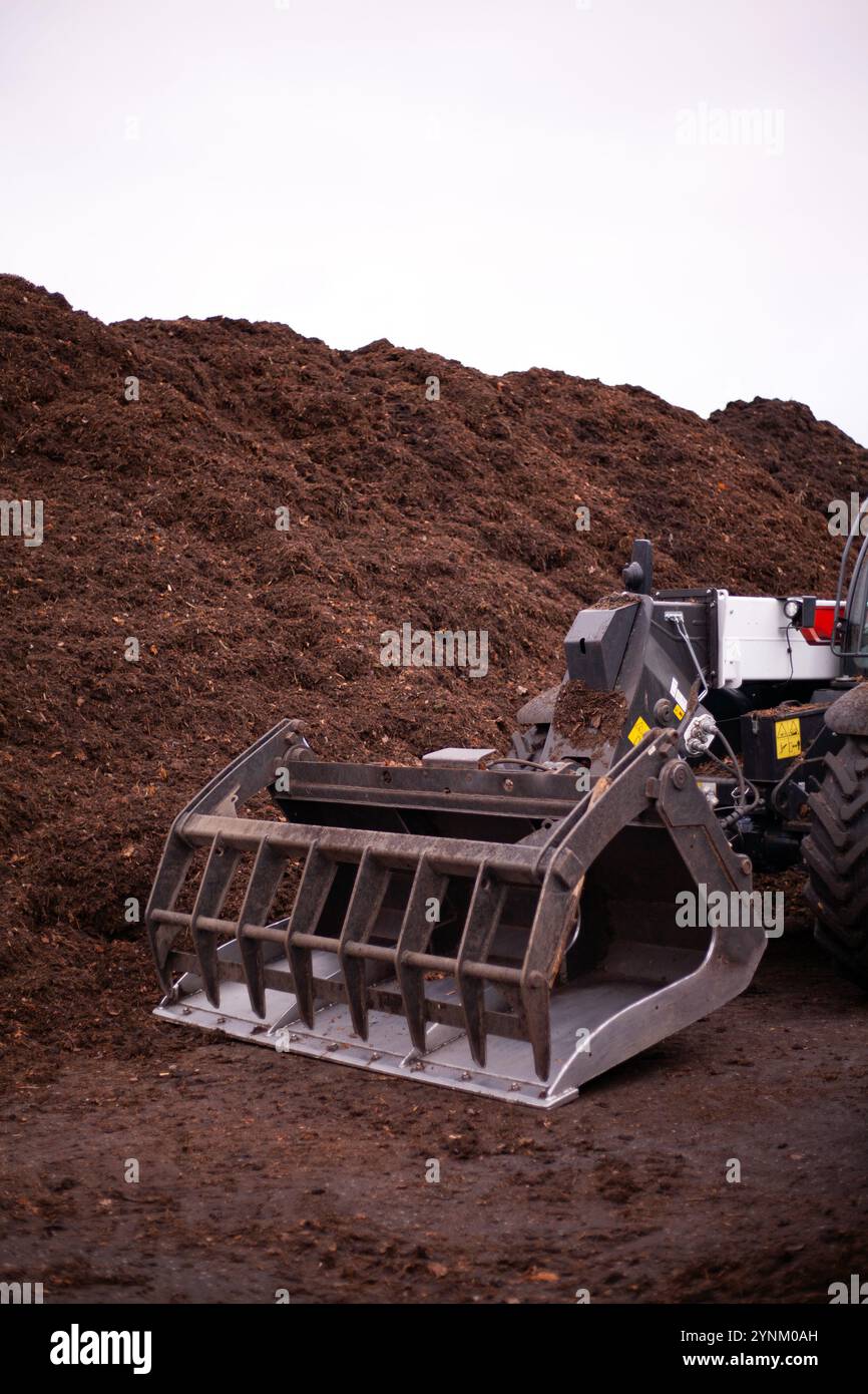 Bucket with grab of tractor for collecting green waste for composting ...