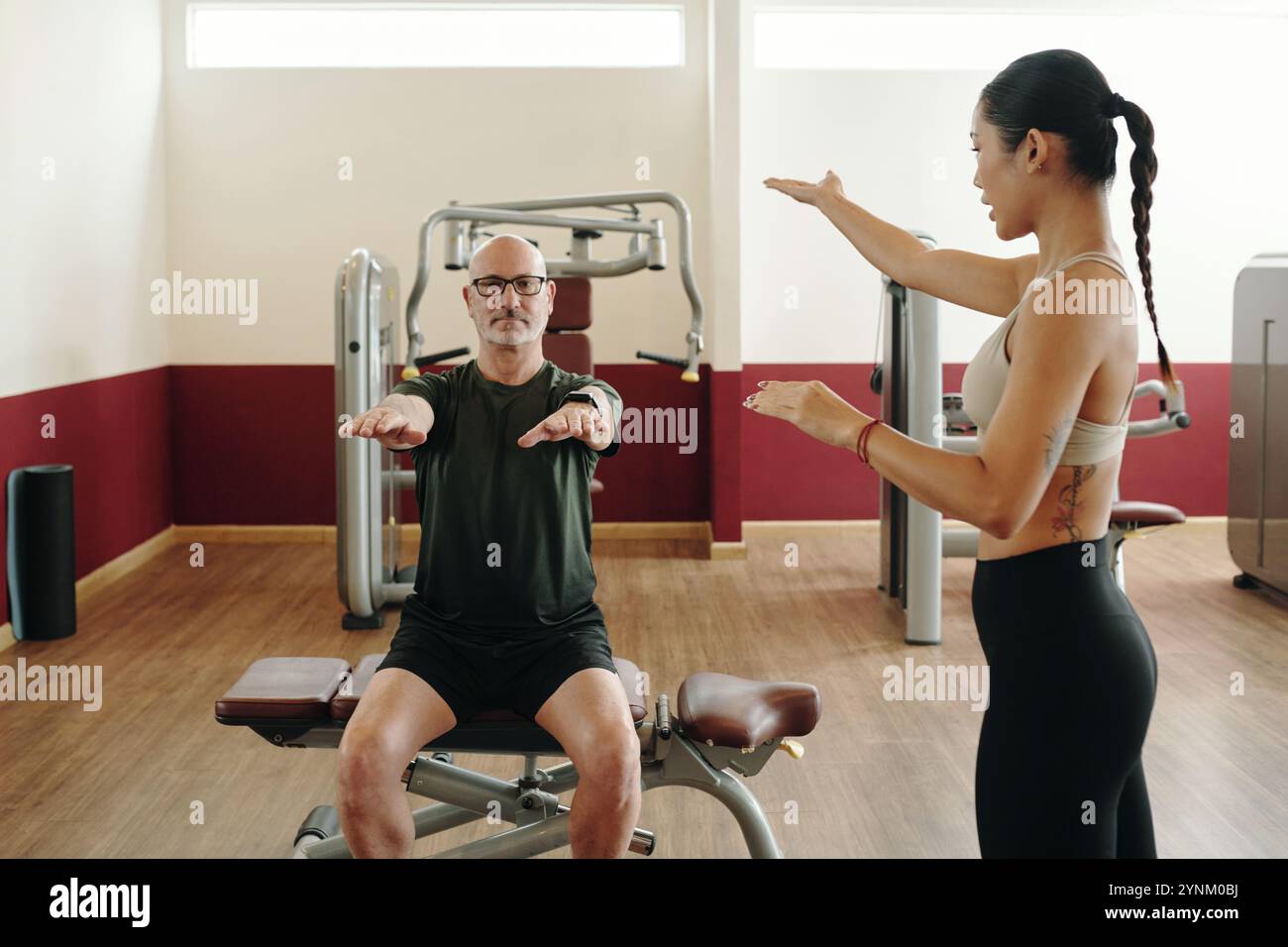 Achieving Fitness Goals with Personal Trainer Guidance Stock Photo - Alamy