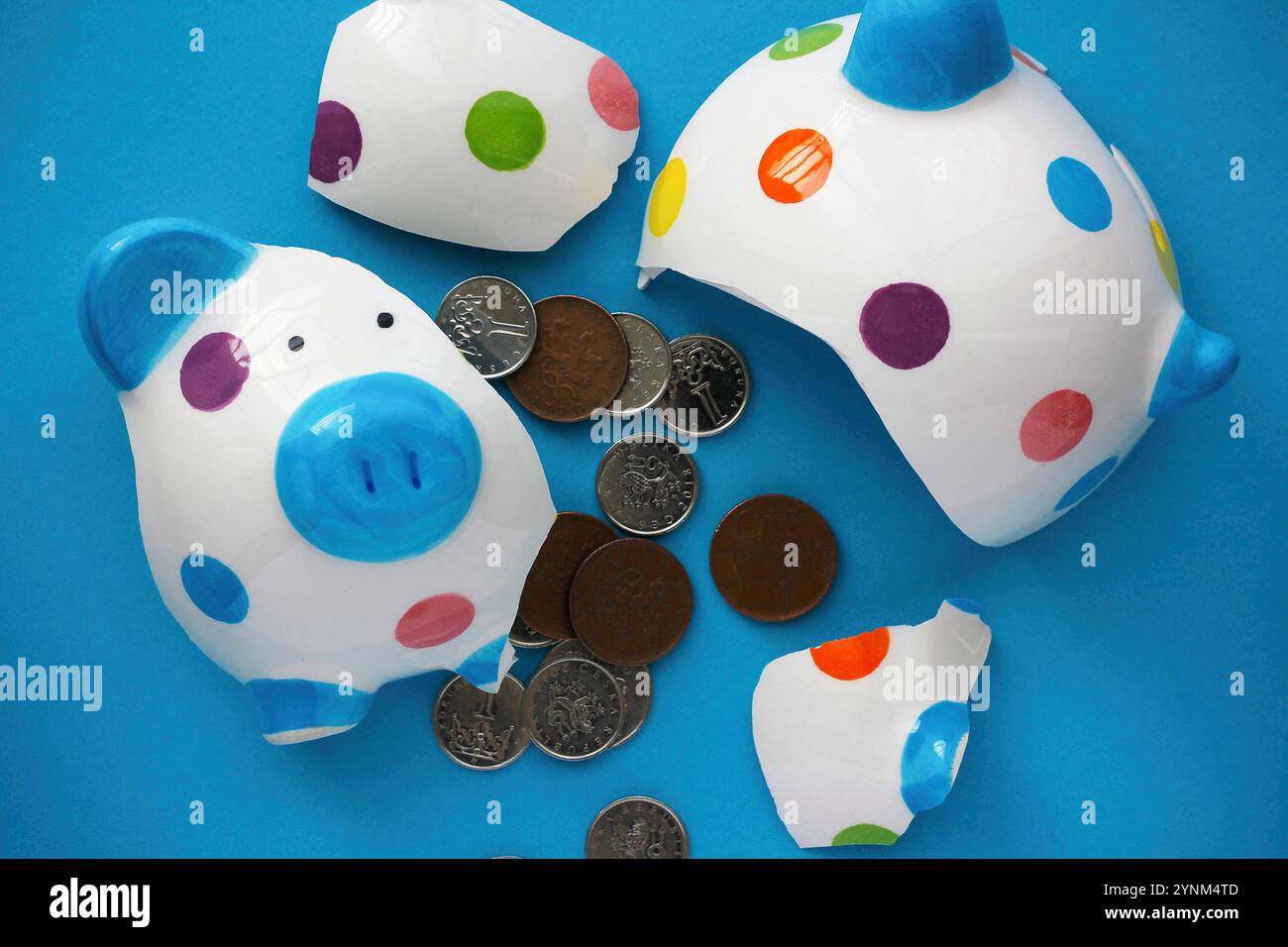 Broken ceramic dotted children's piggy bank with Czech crown coins on ...