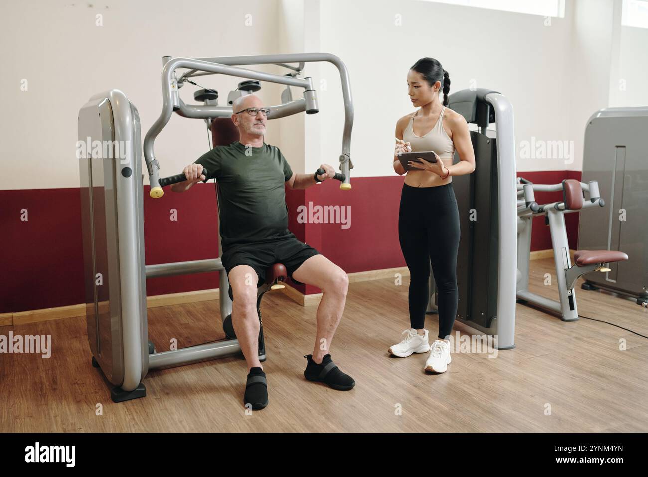 Instructor guiding senior man hi-res stock photography and images - Alamy