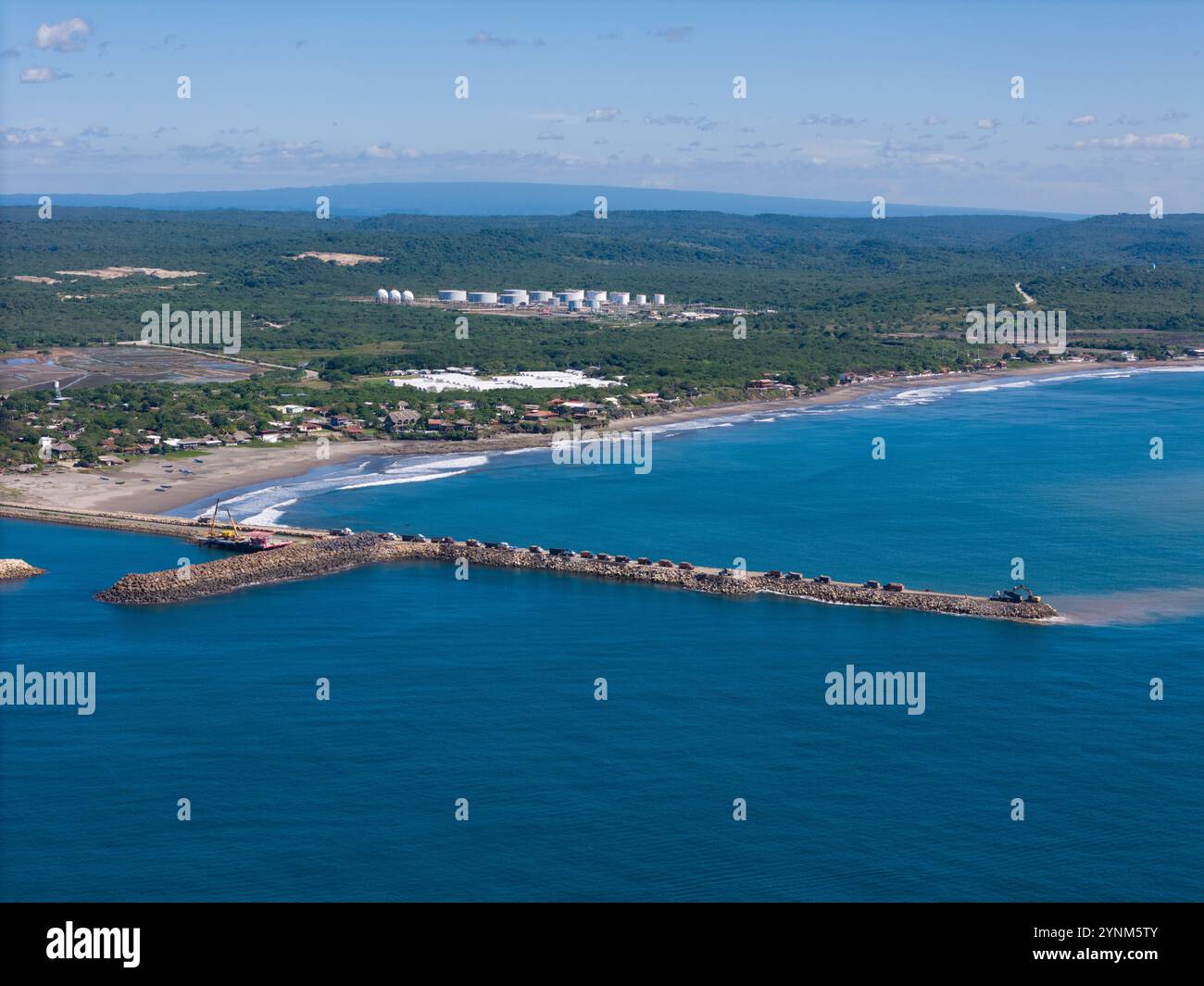 Expansive coastal view captures jetty extending into ocean, surrounded ...