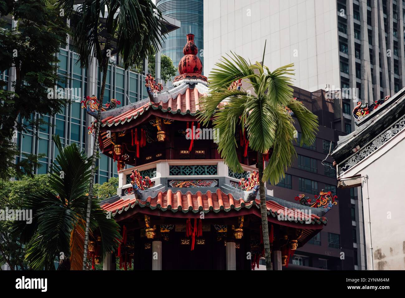 A colored Taoist temple in the middle of the modern architecture of ...