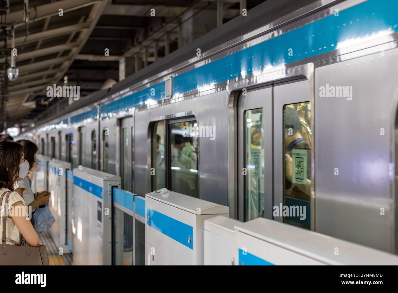Subway train at a station platform with passengers boarding Stock Photo ...