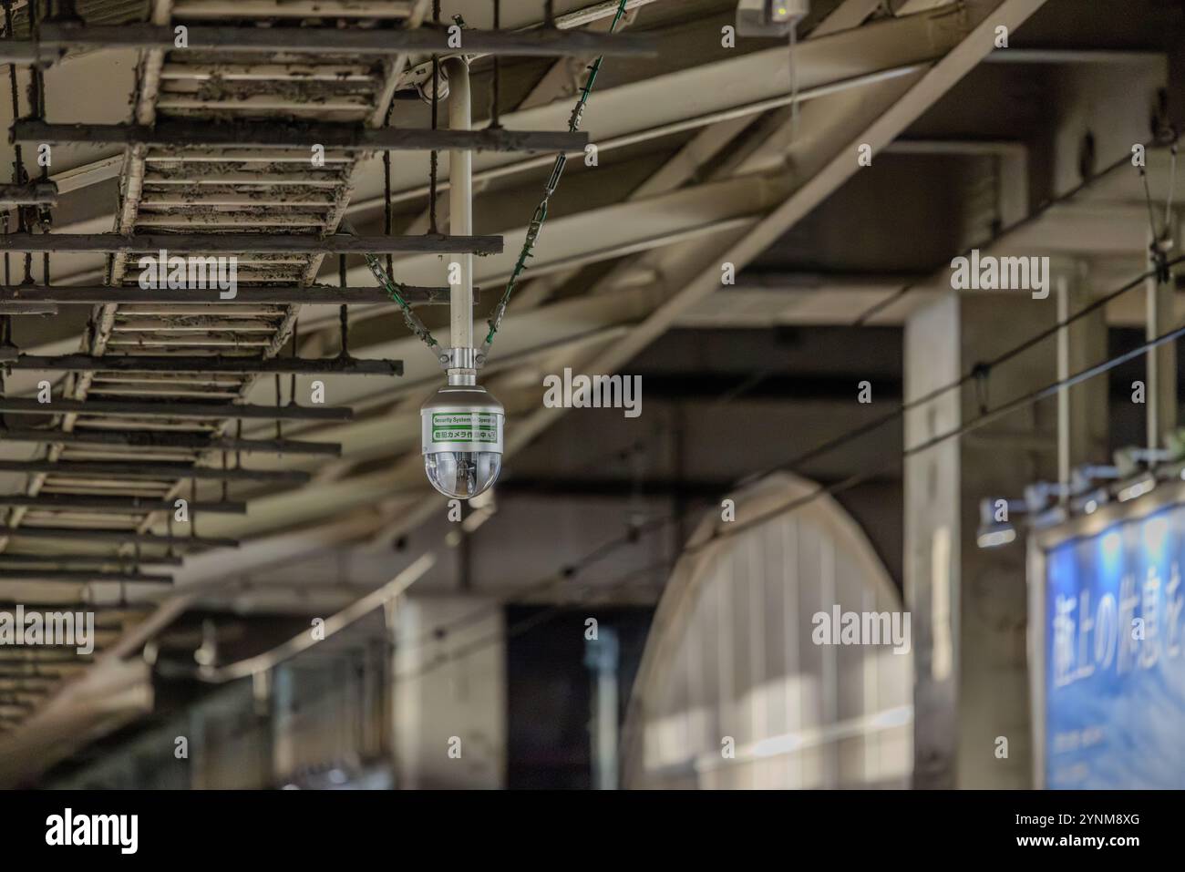 Overhead surveillance camera and structural details at a train station ...