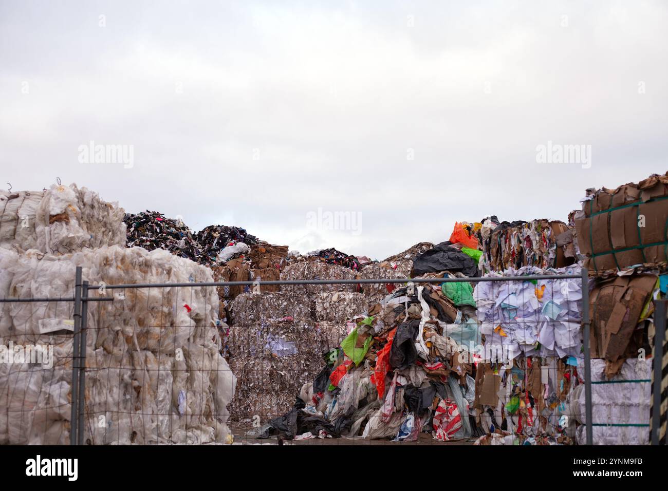 Sorted garbage at the dump behind the fence - plastic, paper, fabric ...