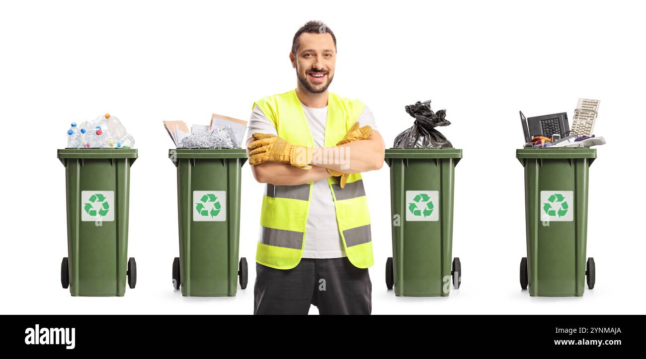 Smiling waste collector in a uniform and gloves in front of bins for ...