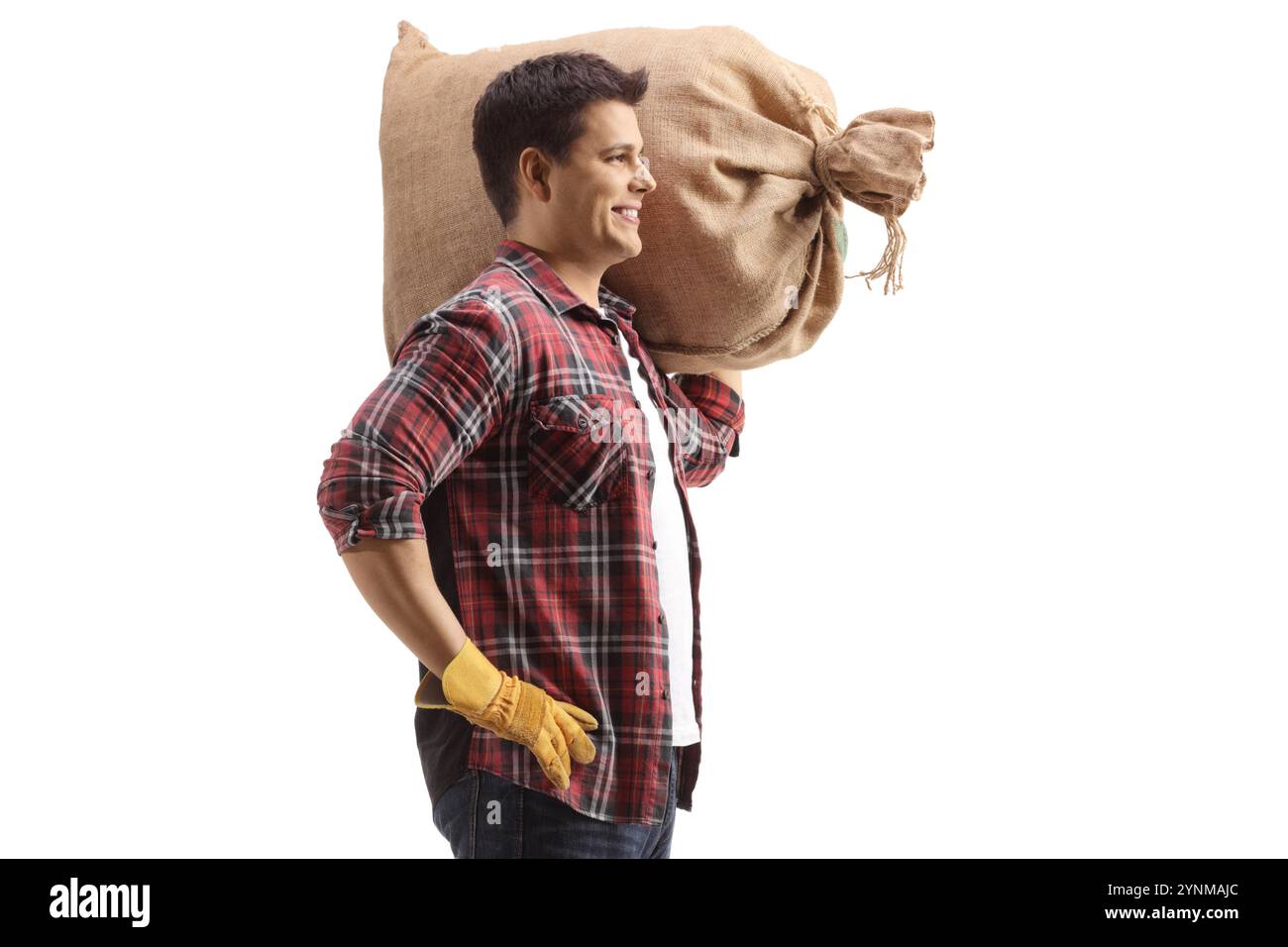 Young farmer carrying a sack on his shoulder isolated on white ...