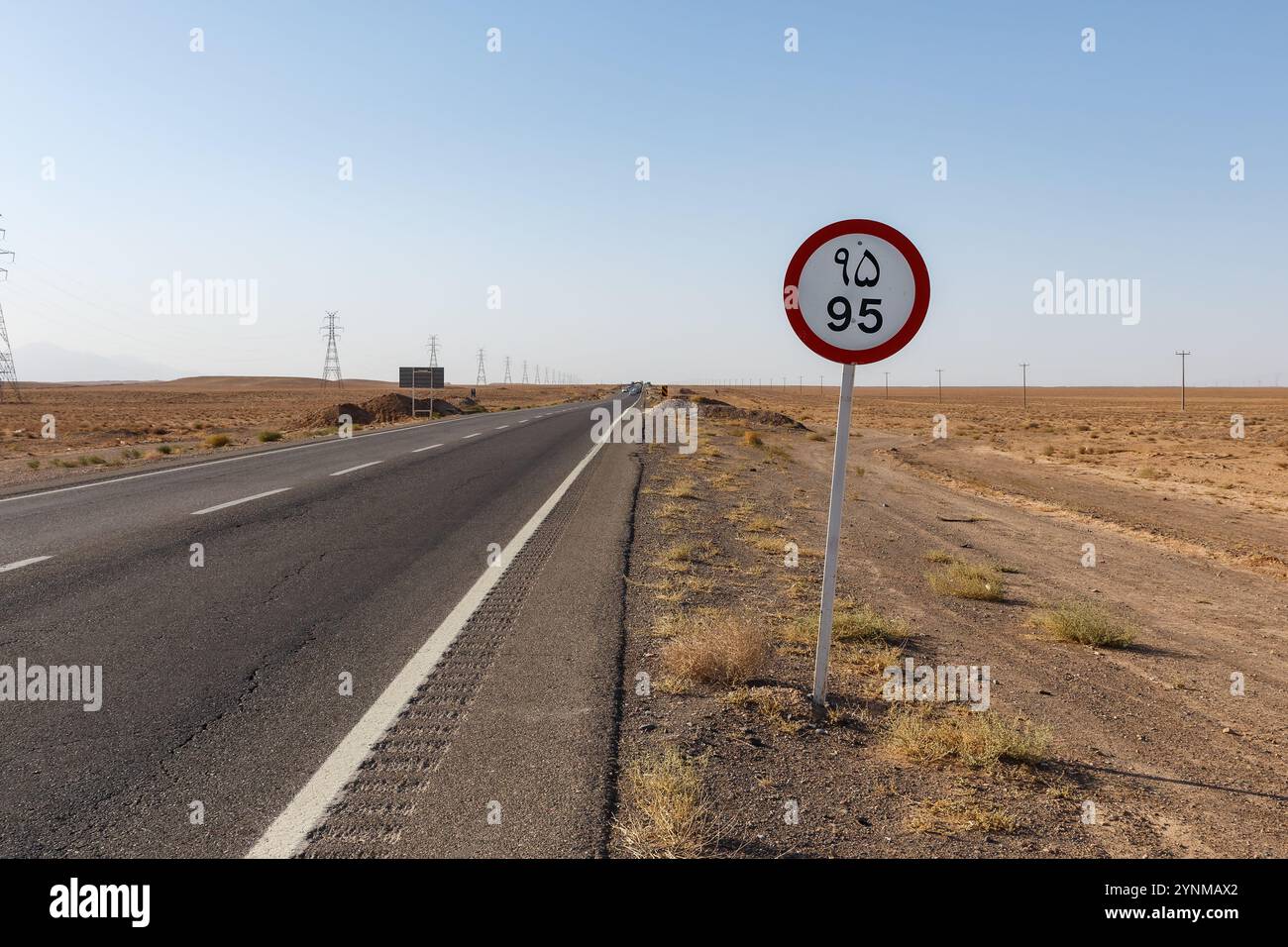 Stretching into the distance, a lonely asphalt road cuts through the ...