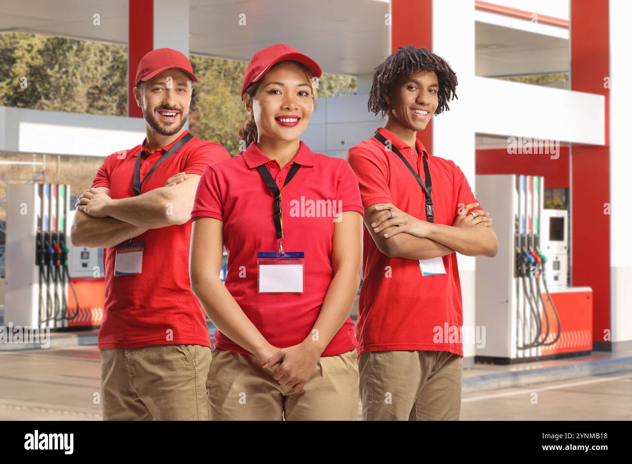 Team of workers posing at a gas station Stock Photo - Alamy