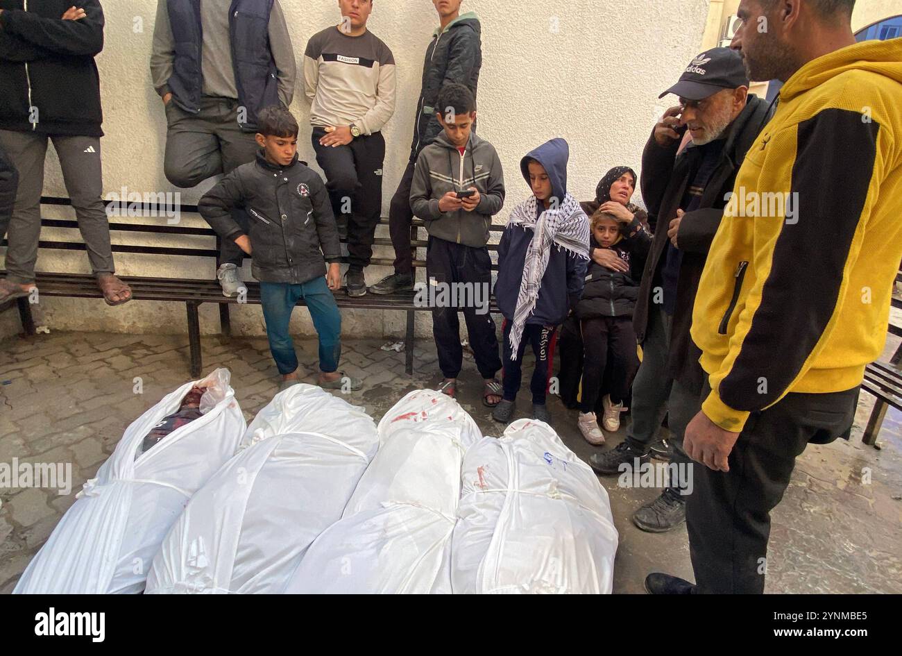 Palestinian bodies are carried into Al-Ahli Arab hospital, also known ...