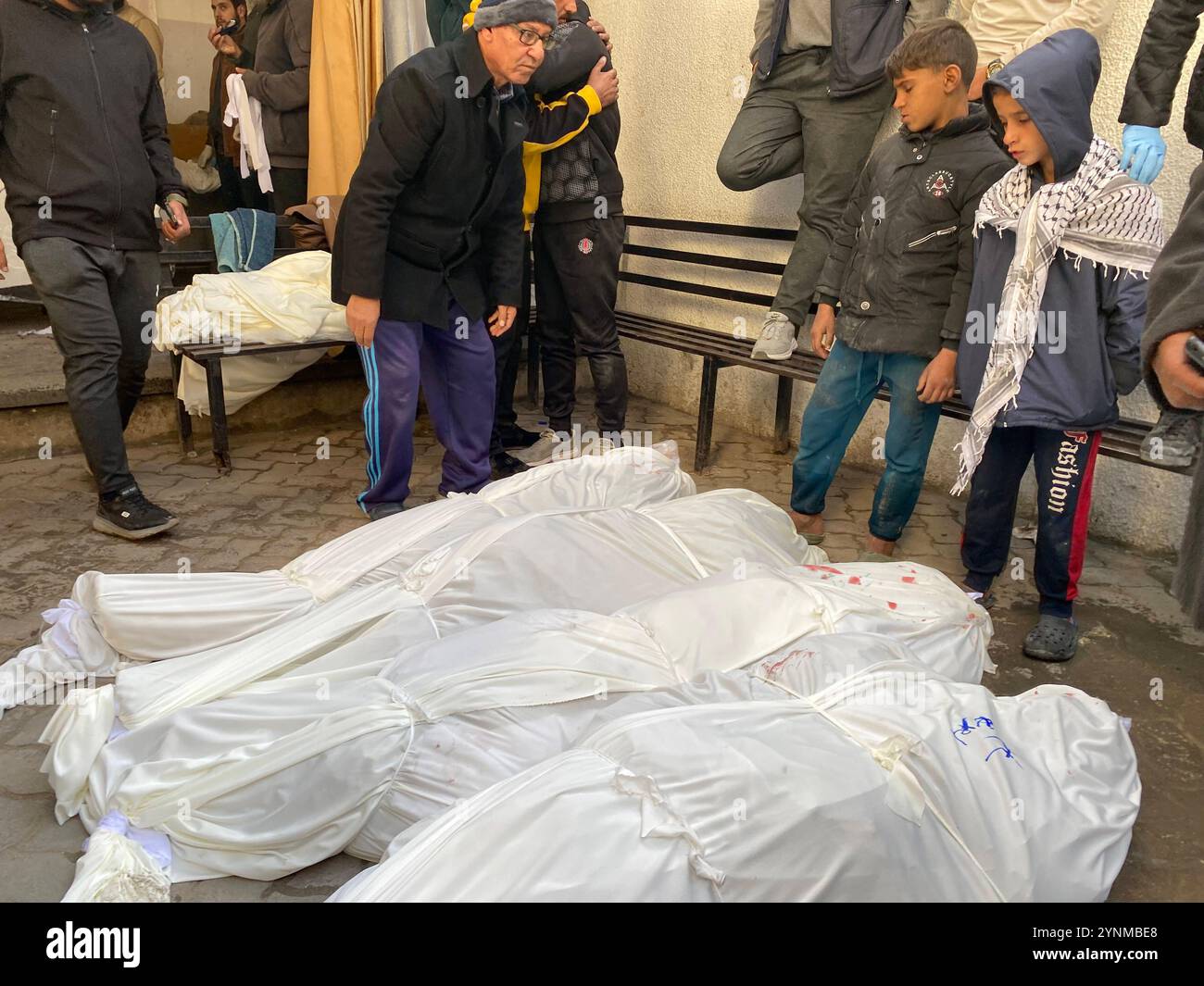Palestinian bodies are carried into Al-Ahli Arab hospital, also known ...