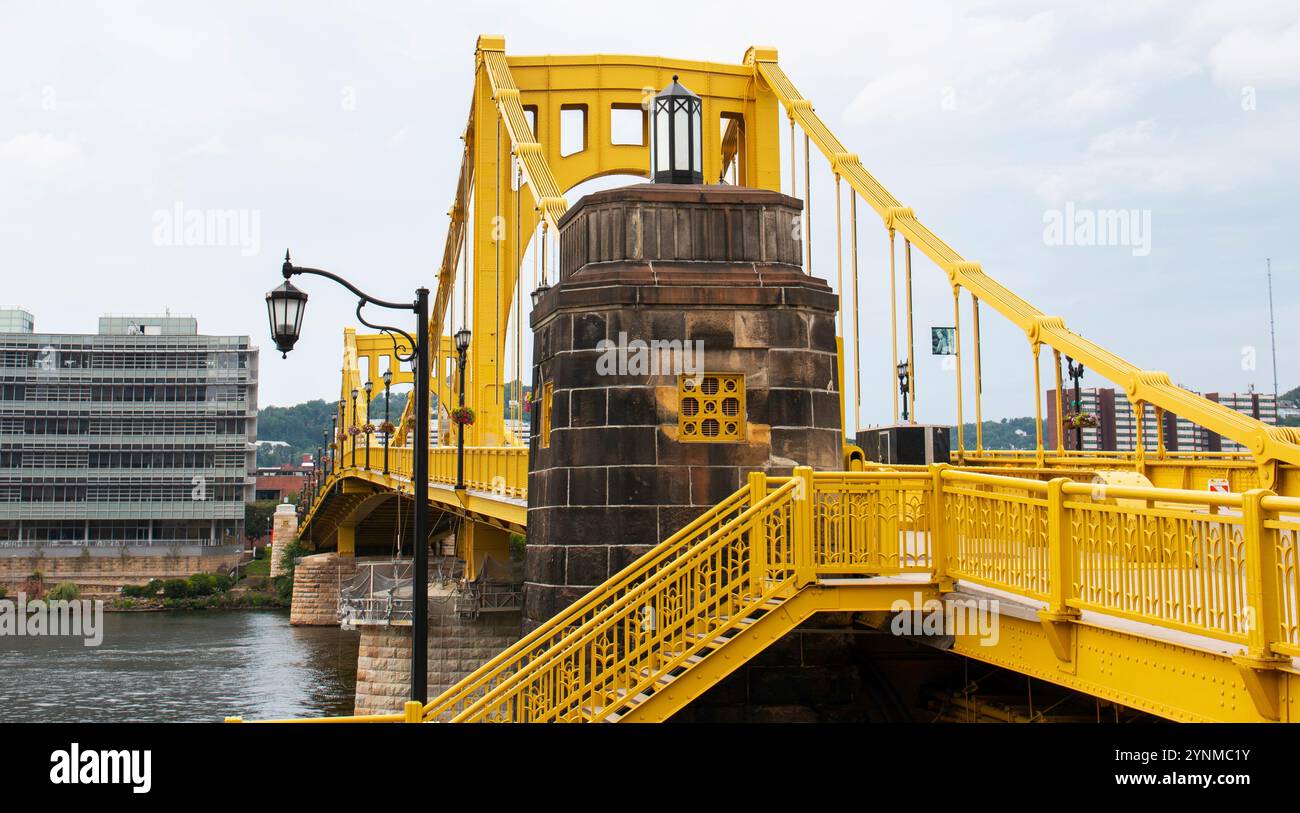 A striking yellow bridge stands prominently above the river, featuring ...