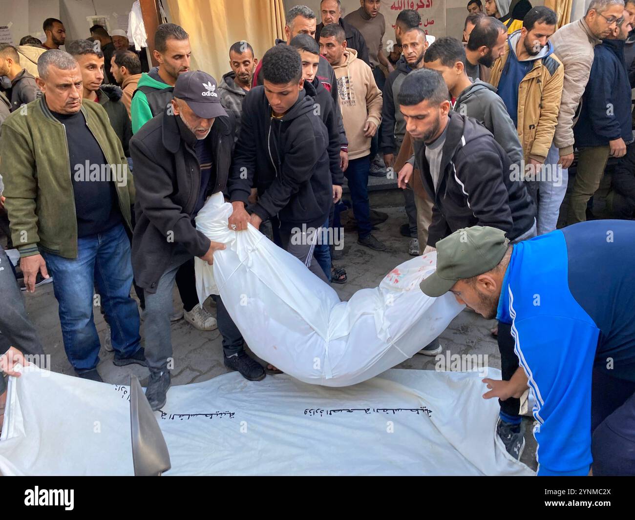 Palestinian bodies are carried into Al-Ahli Arab hospital, also known ...