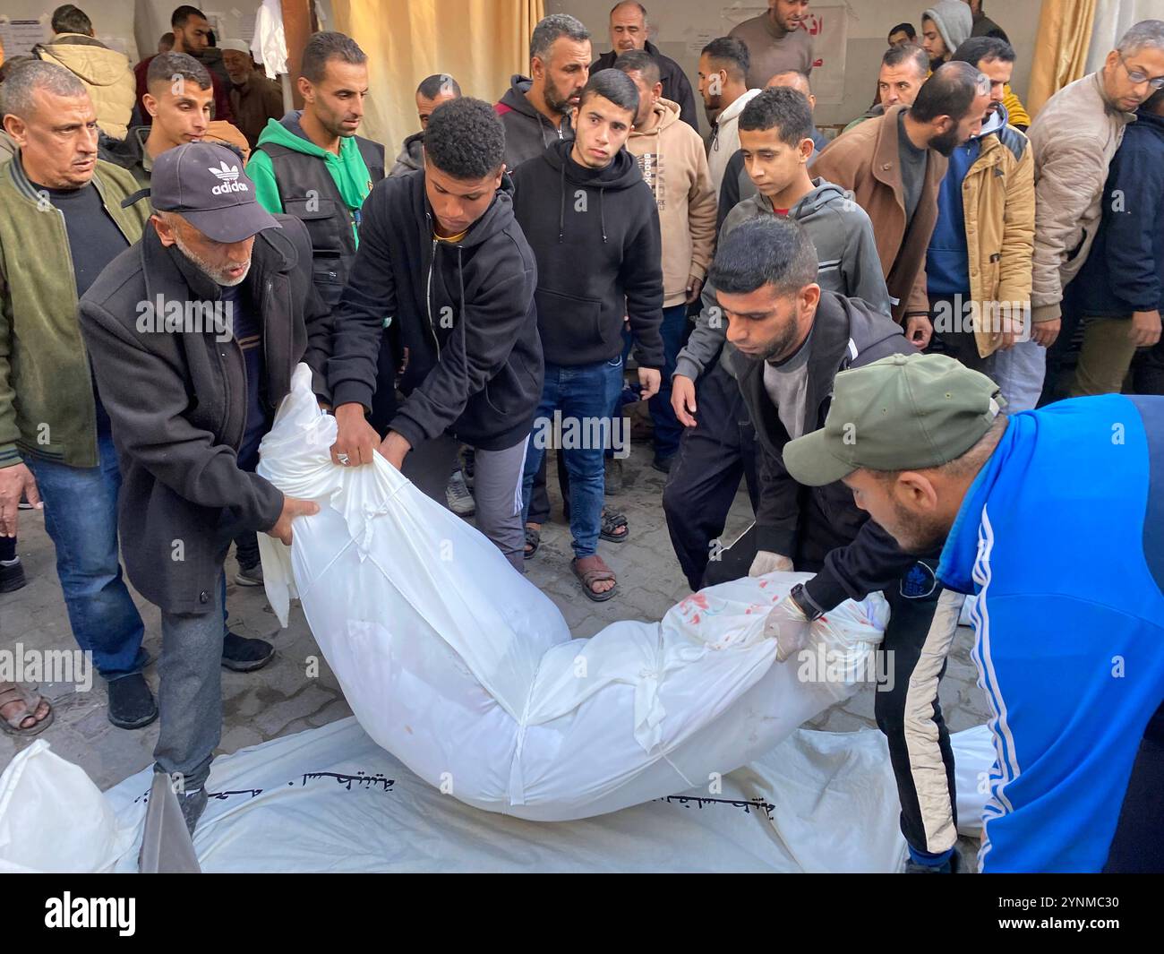 Palestinian bodies are carried into Al-Ahli Arab hospital, also known ...